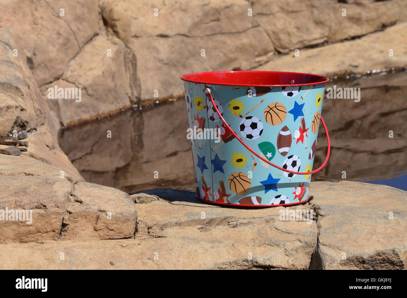 Bucket on the Rock Wall Stock Photo - Alamy