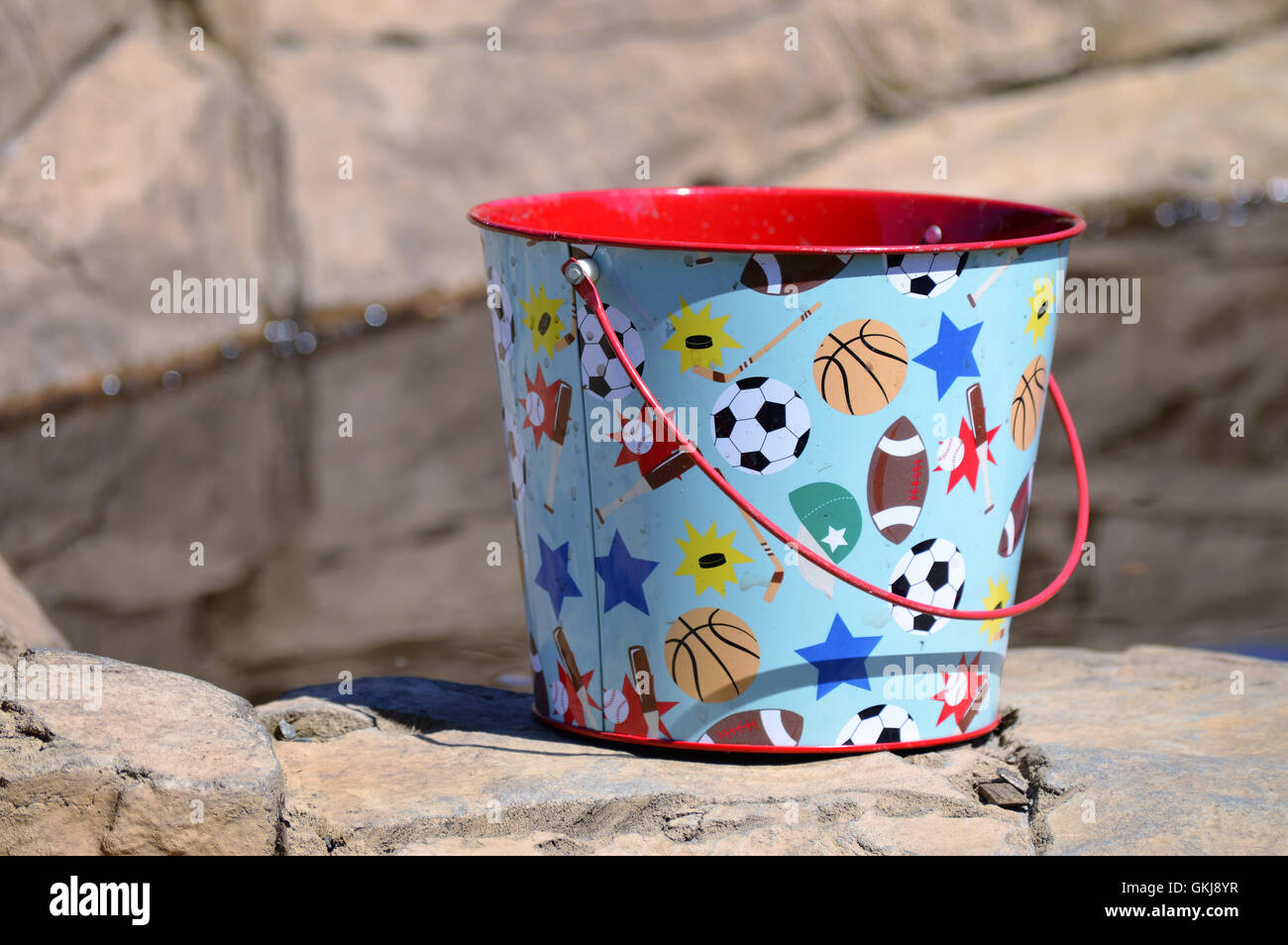 Bucket on the Rock Wall Stock Photo - Alamy