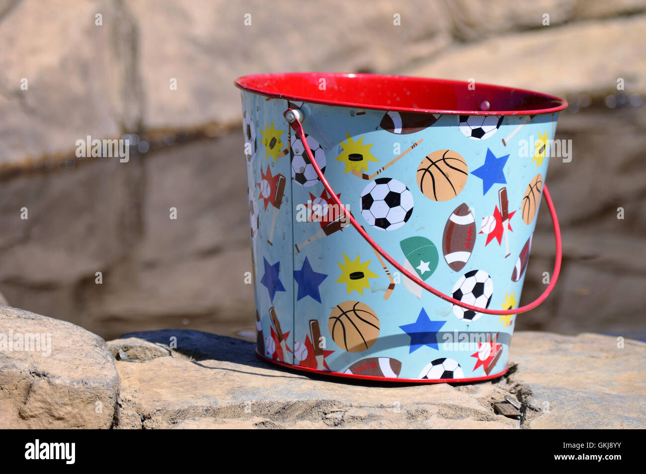 Bucket on the Rock Wall Stock Photo - Alamy