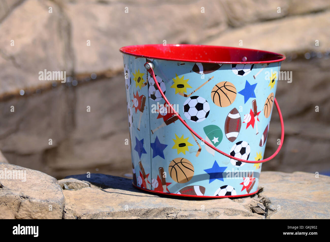 Bucket on the Rock Wall Stock Photo - Alamy
