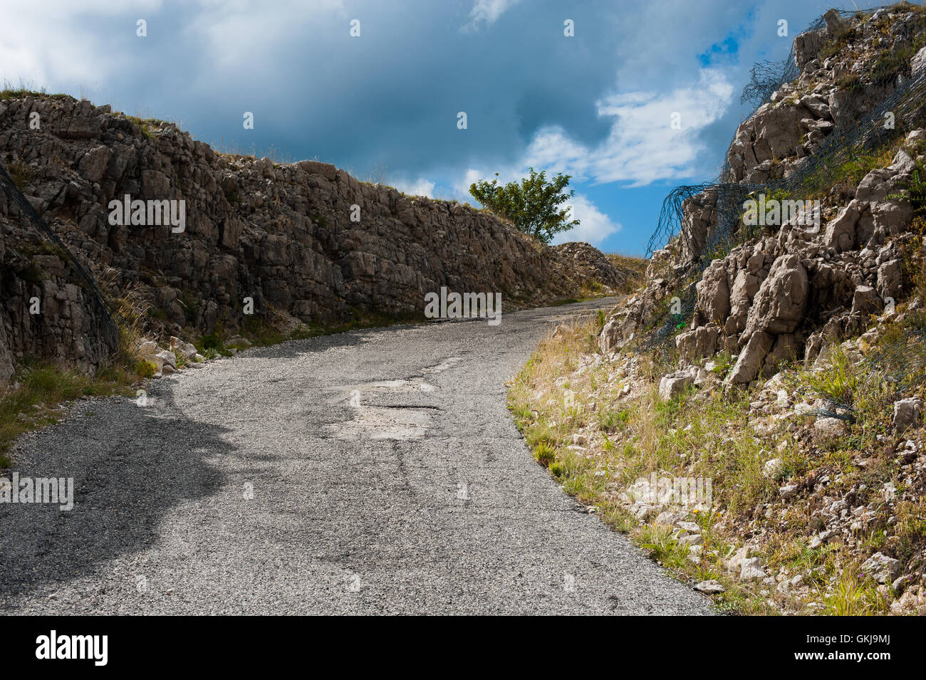 Road path to the unknown between stone walls, way to reaching the top ...
