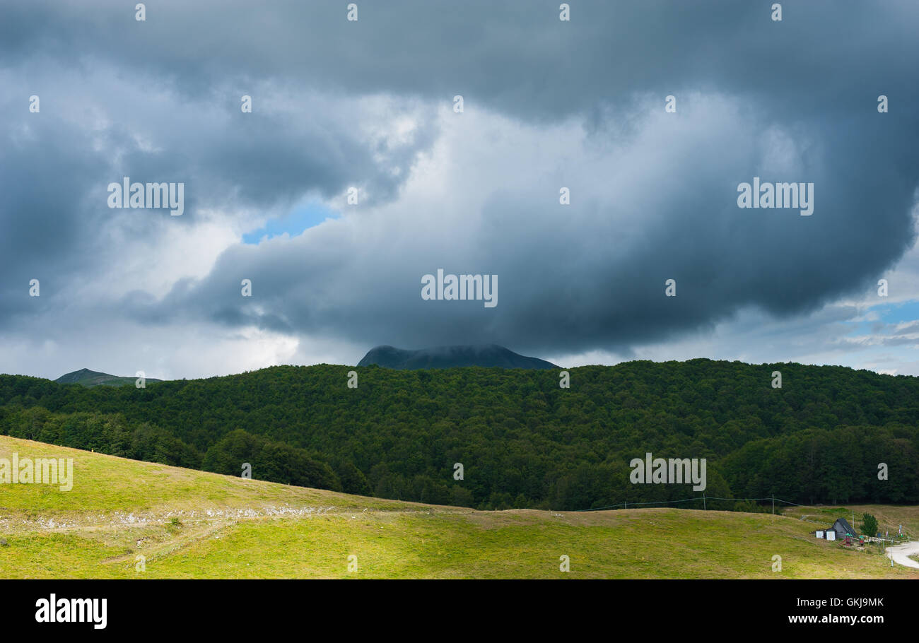 Green mountain landscape with dramatic dark stormy sky and clouds Stock ...