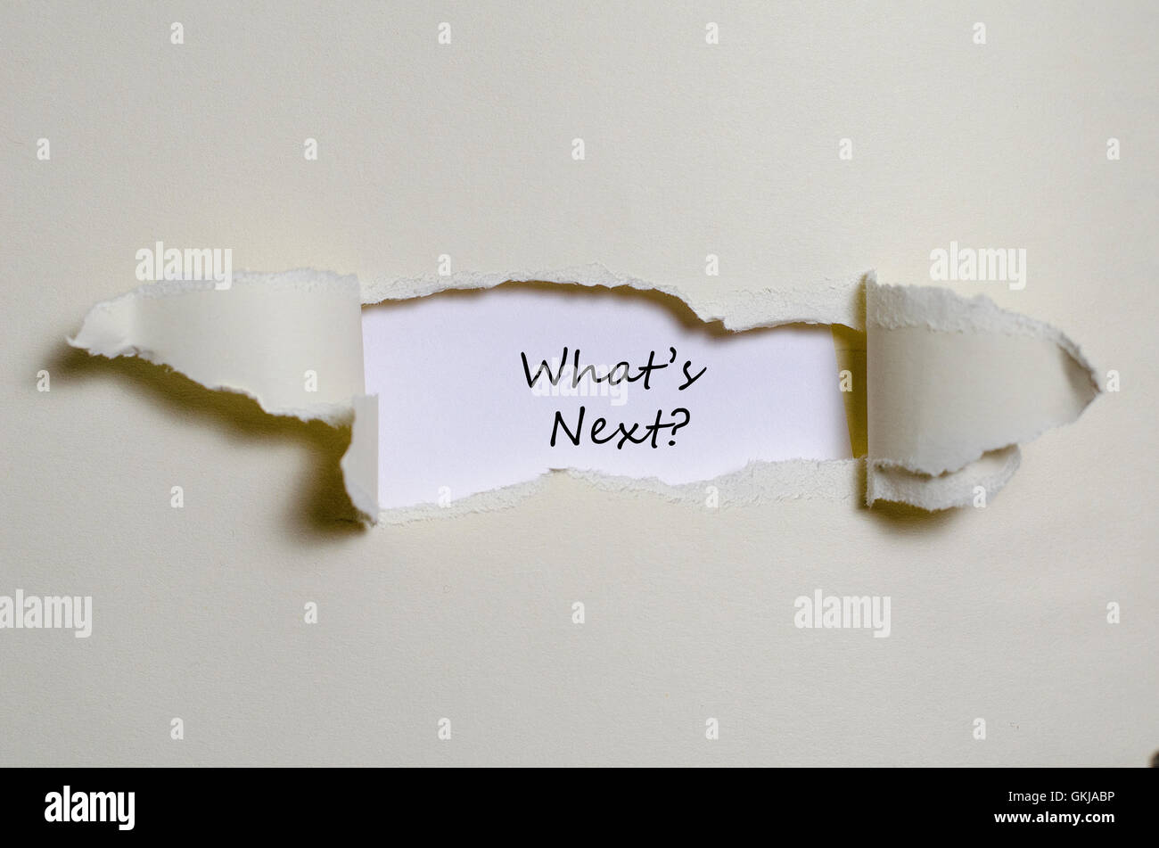 The words what's next appearing behind torn paper Stock Photo - Alamy