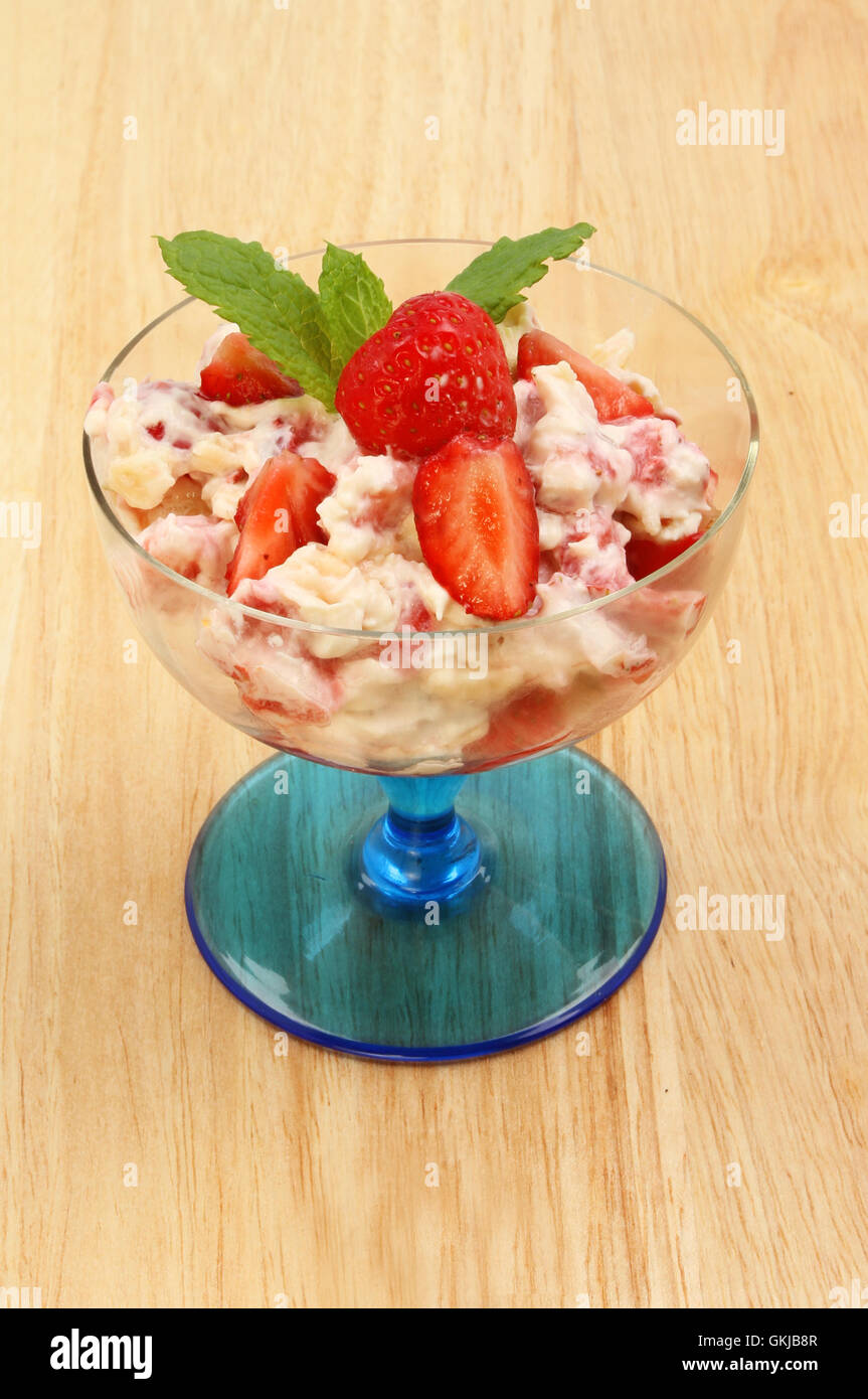 Eton mess, strawberries, crushed meringue and cream in a sundae glass ...