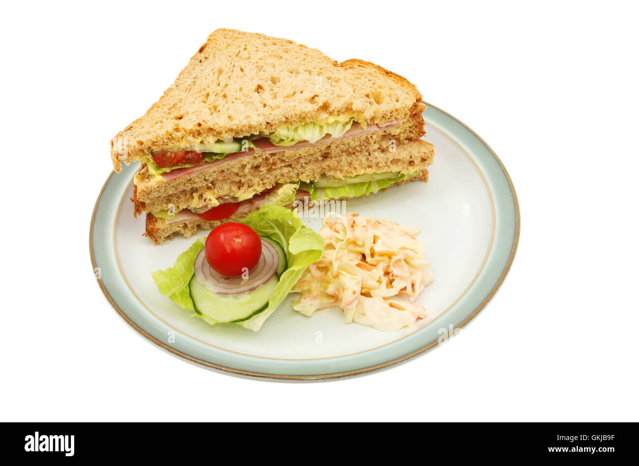 Ham salad sandwich with salad garnish and coleslaw on a plate isolated ...