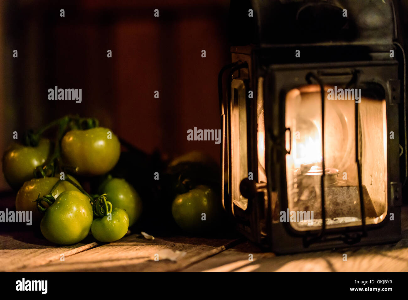 Homegrown green tomatoes by lantern at night alfresco dining Stock ...