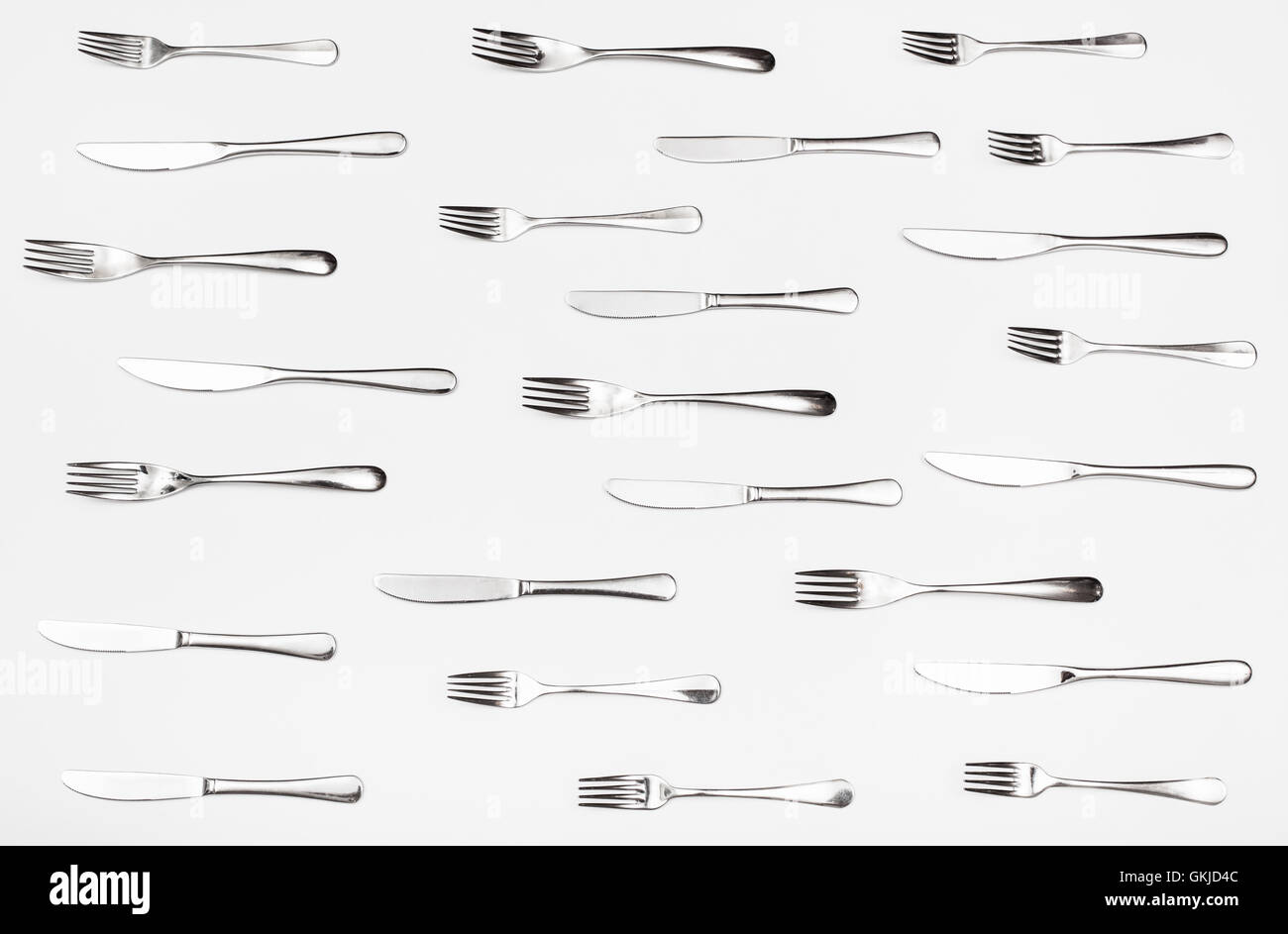 top view of many table knives and forks on white background Stock Photo ...