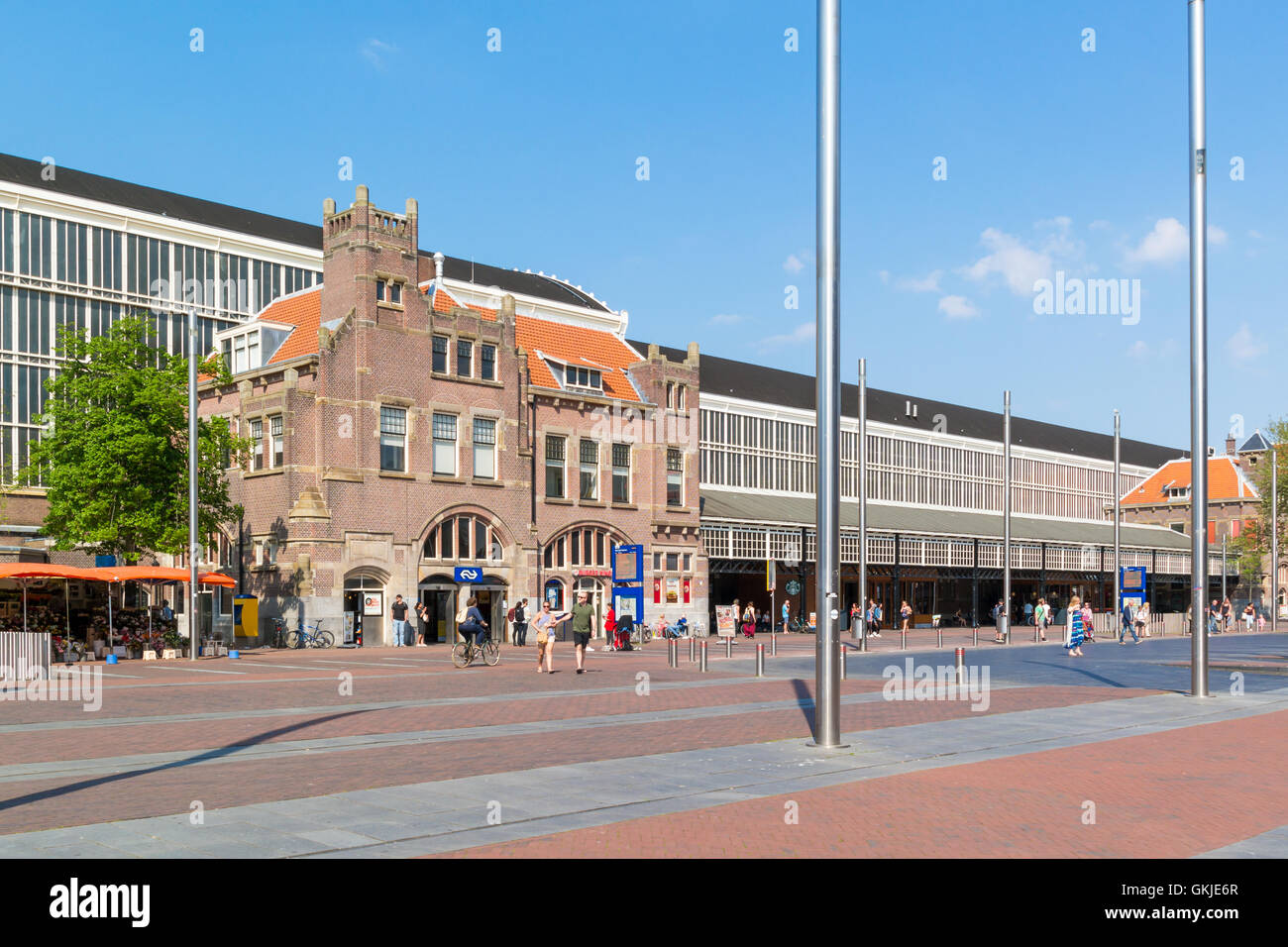 People and station building on Stationsplein square in city of Haarlem ...