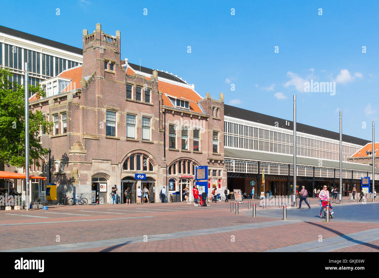 People and station building on Stationsplein square in city of Haarlem ...