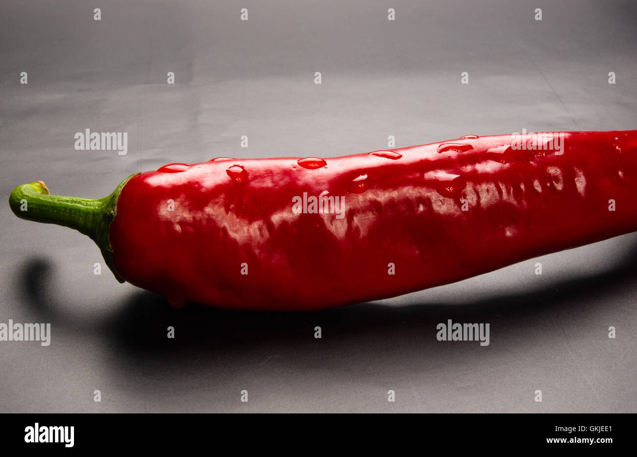 Red chili pepper on a black background Stock Photo - Alamy