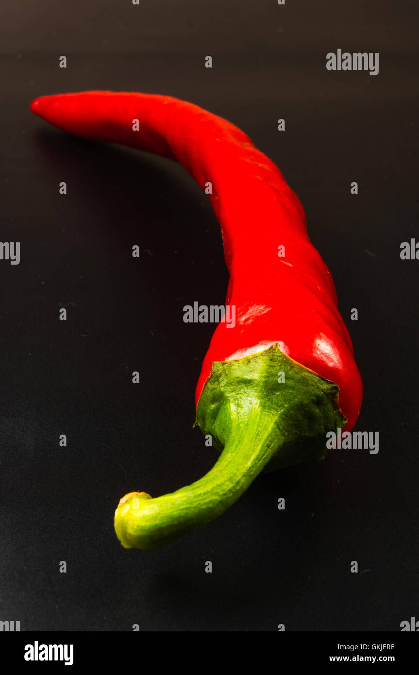 Red chili pepper on a black background Stock Photo - Alamy