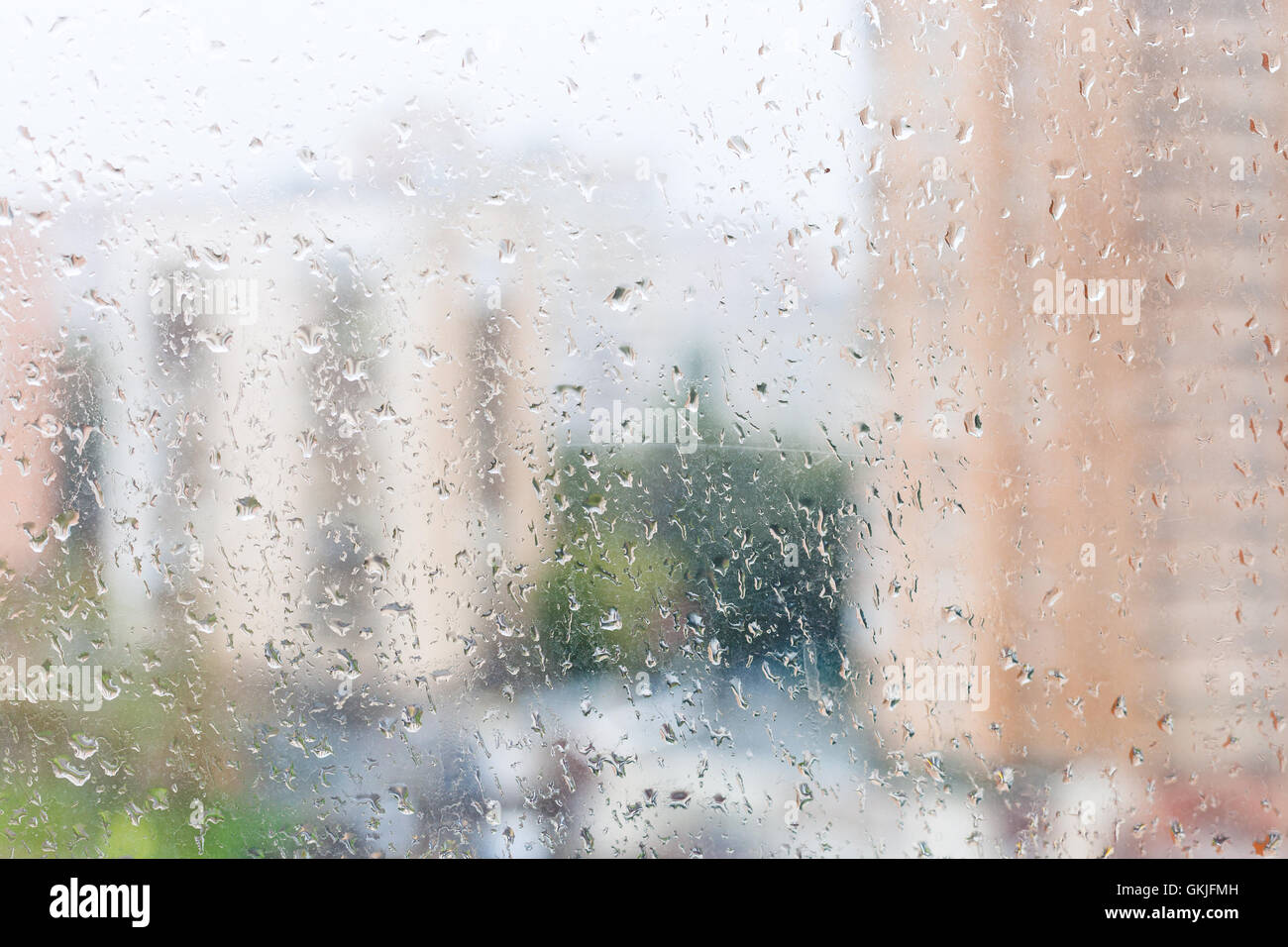 rainy weather in city - view of wet window glass of urban house Stock ...