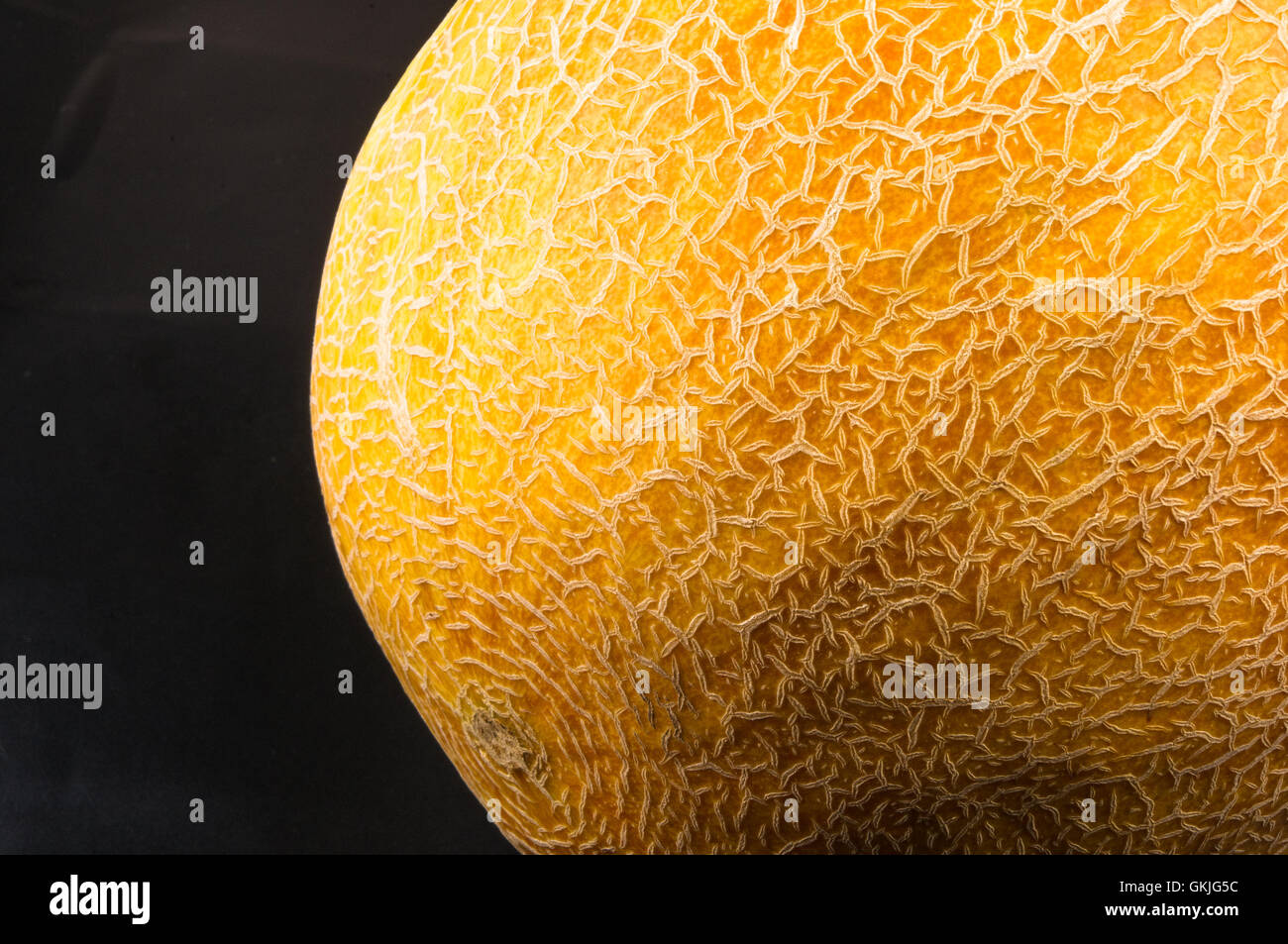 big ripe juicy melon on black background Stock Photo - Alamy