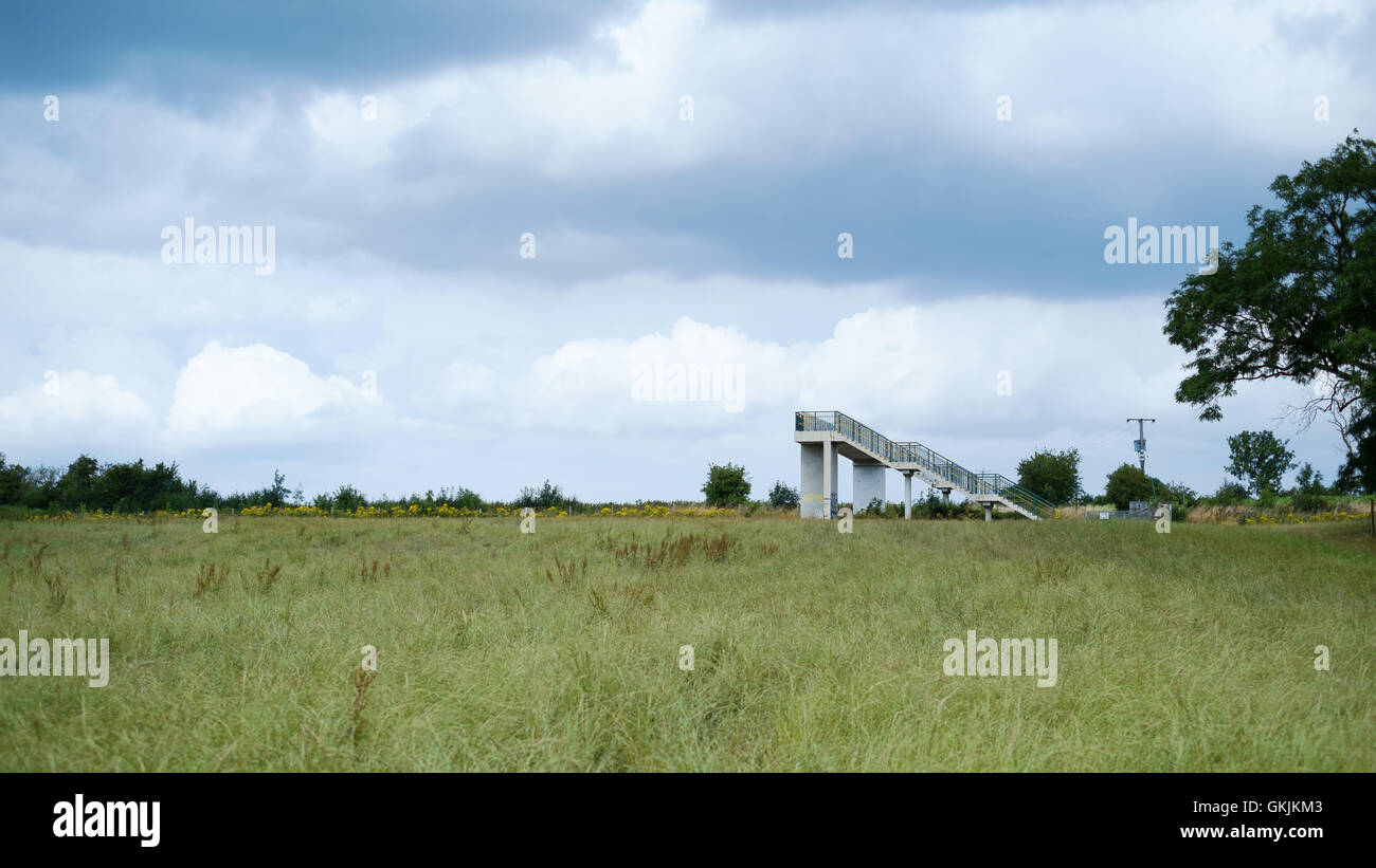Walkway over train track in field Stock Photo - Alamy