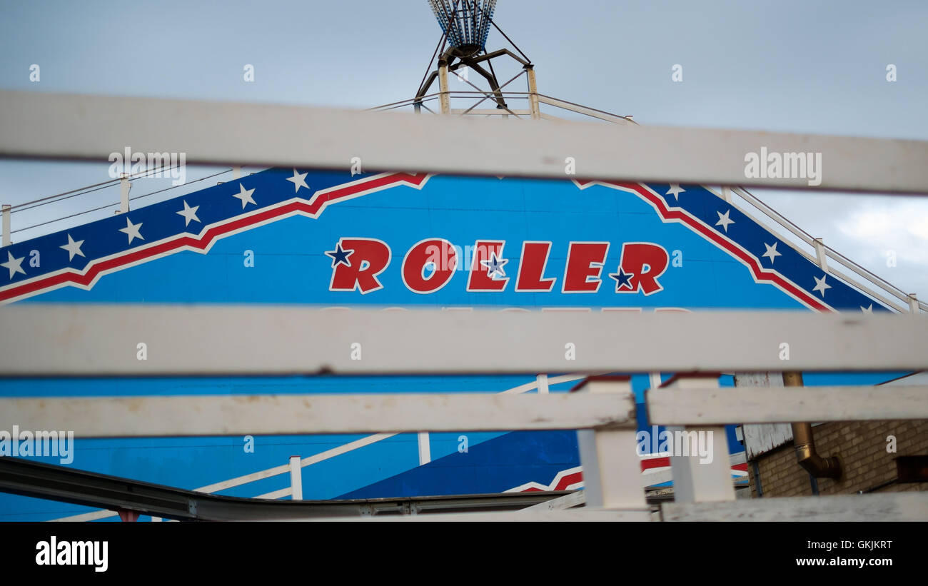 Rollercoaster sign behind railings Stock Photo - Alamy