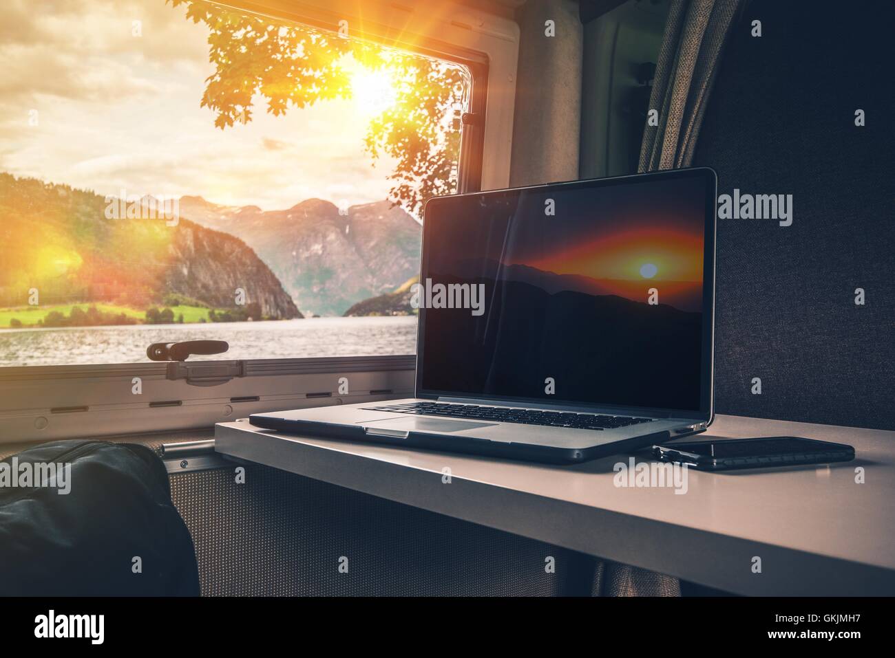 Working While Traveling. Laptop Computer on a Camper Table with Scenic ...