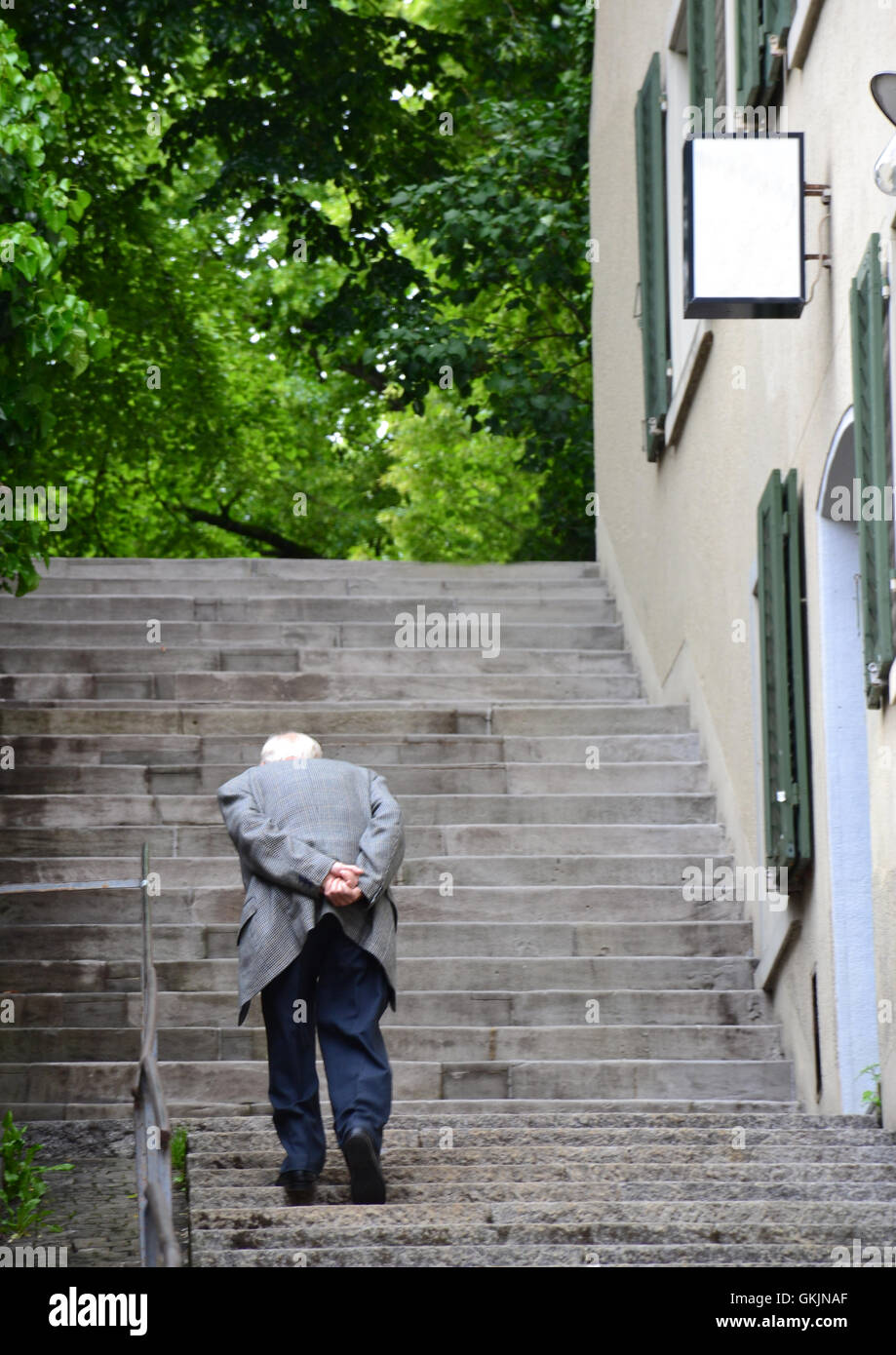 Old man climbing stairs Stock Photo - Alamy