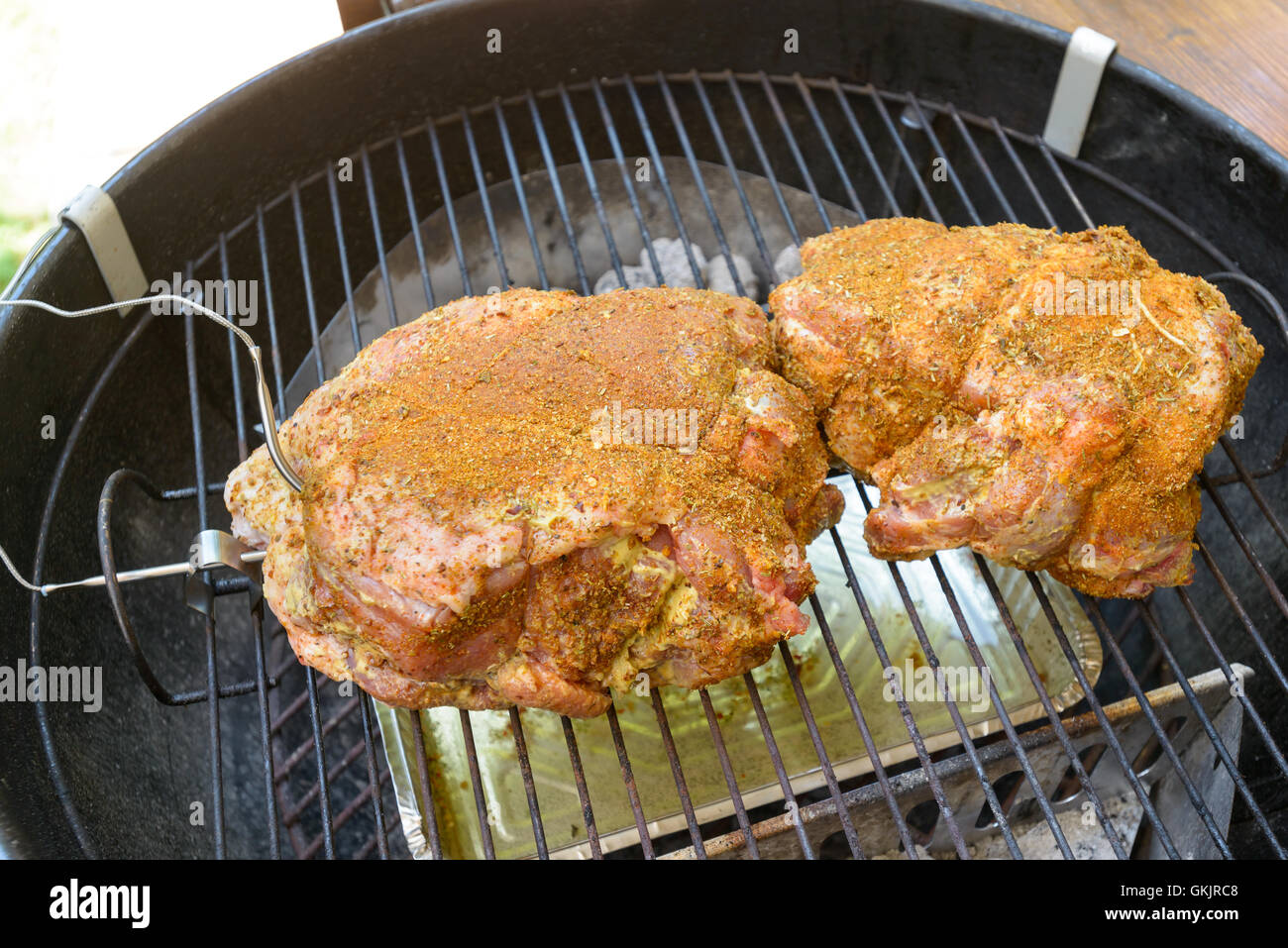 Pulled pork cooking and grilling inside a barbecue Stock Photo - Alamy