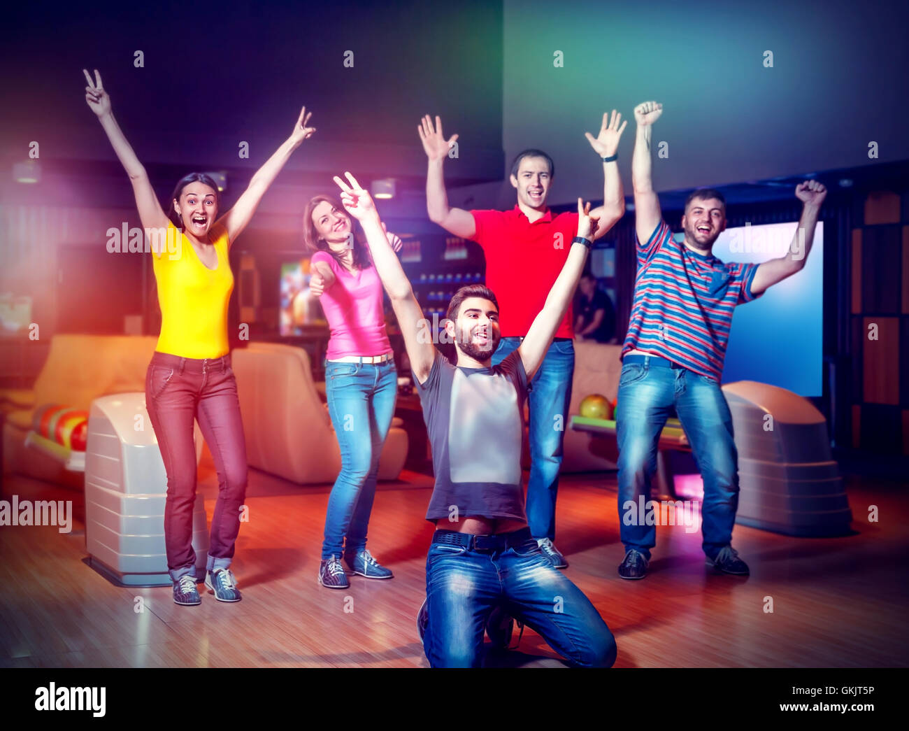 Happy team in bowling Stock Photo - Alamy
