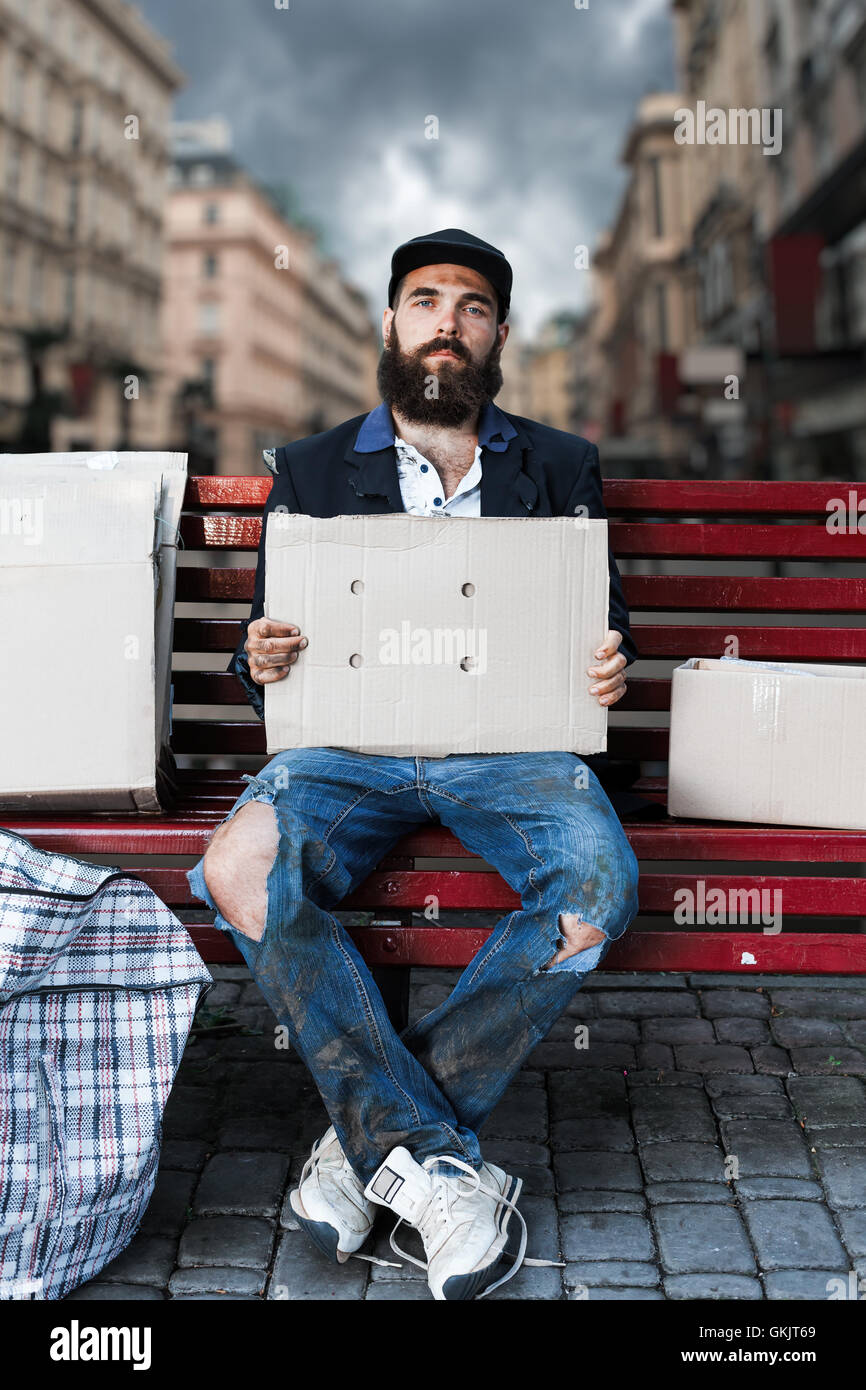Vagrant with cardboard Stock Photo - Alamy