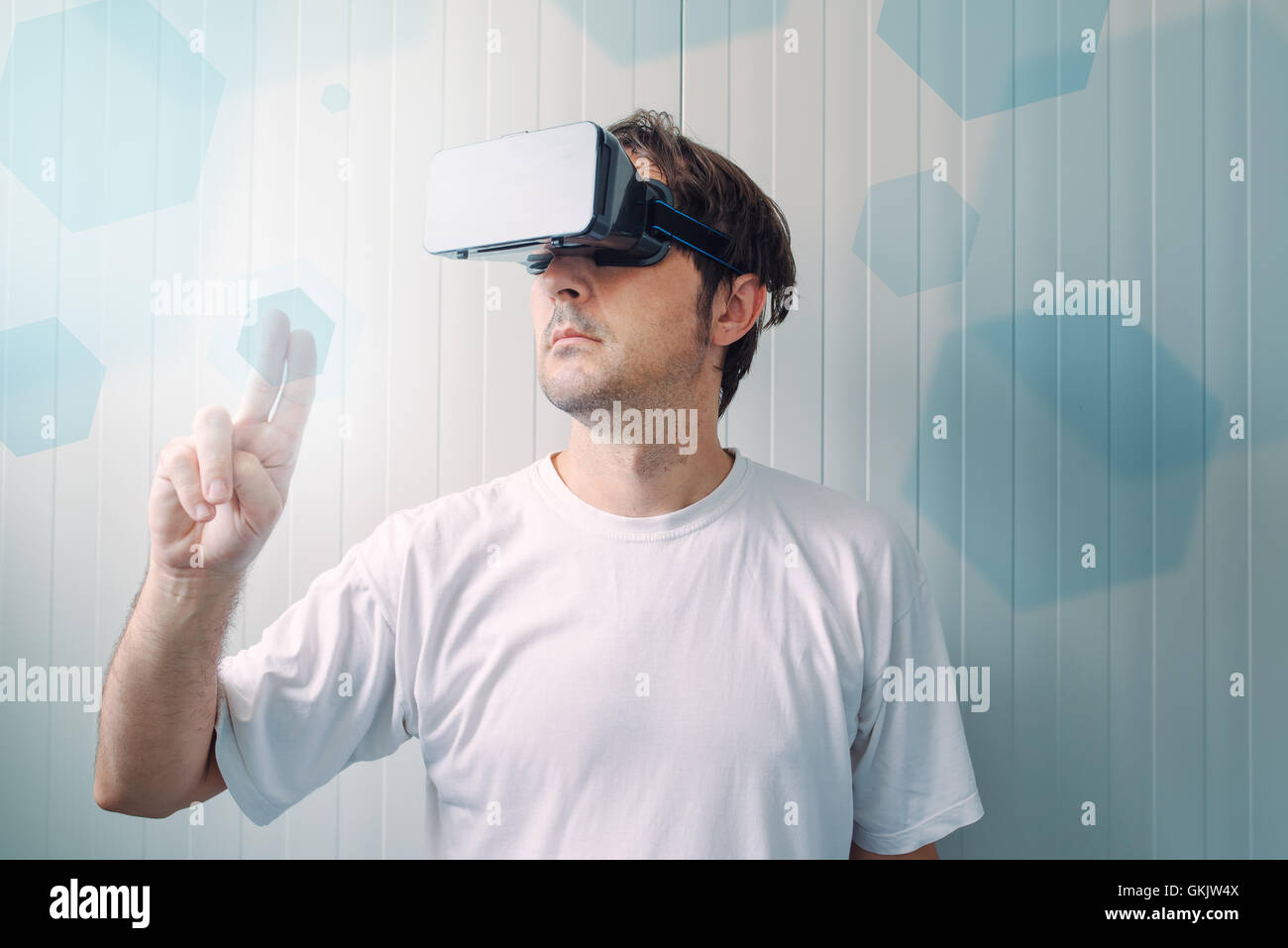 Man with VR goggles working in virtual reality environment, casual male ...
