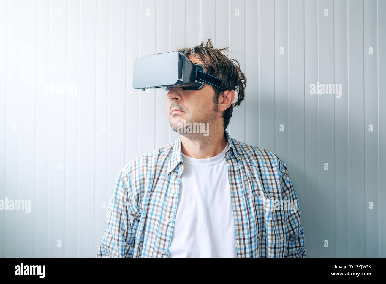 Guy with VR goggles exploring virtual reality environment Stock Photo ...