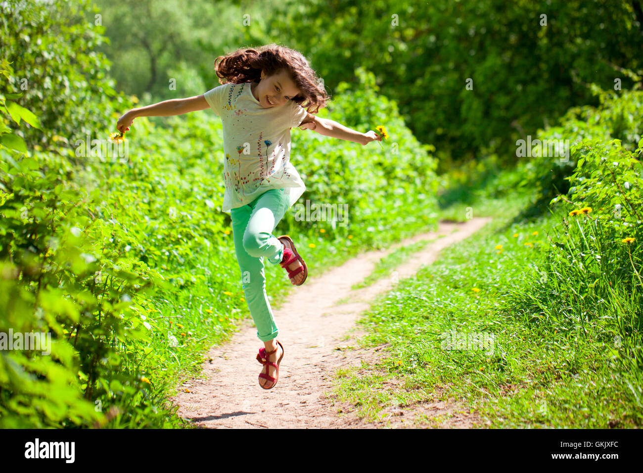 Happy little girl running in summer park Stock Photo - Alamy