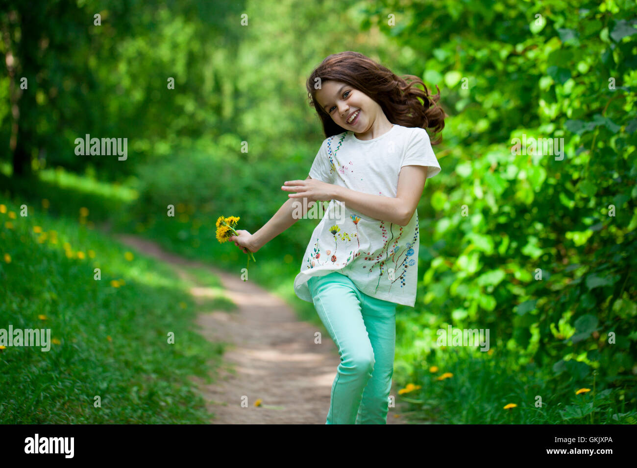 Happy little girl running in summer park Stock Photo - Alamy