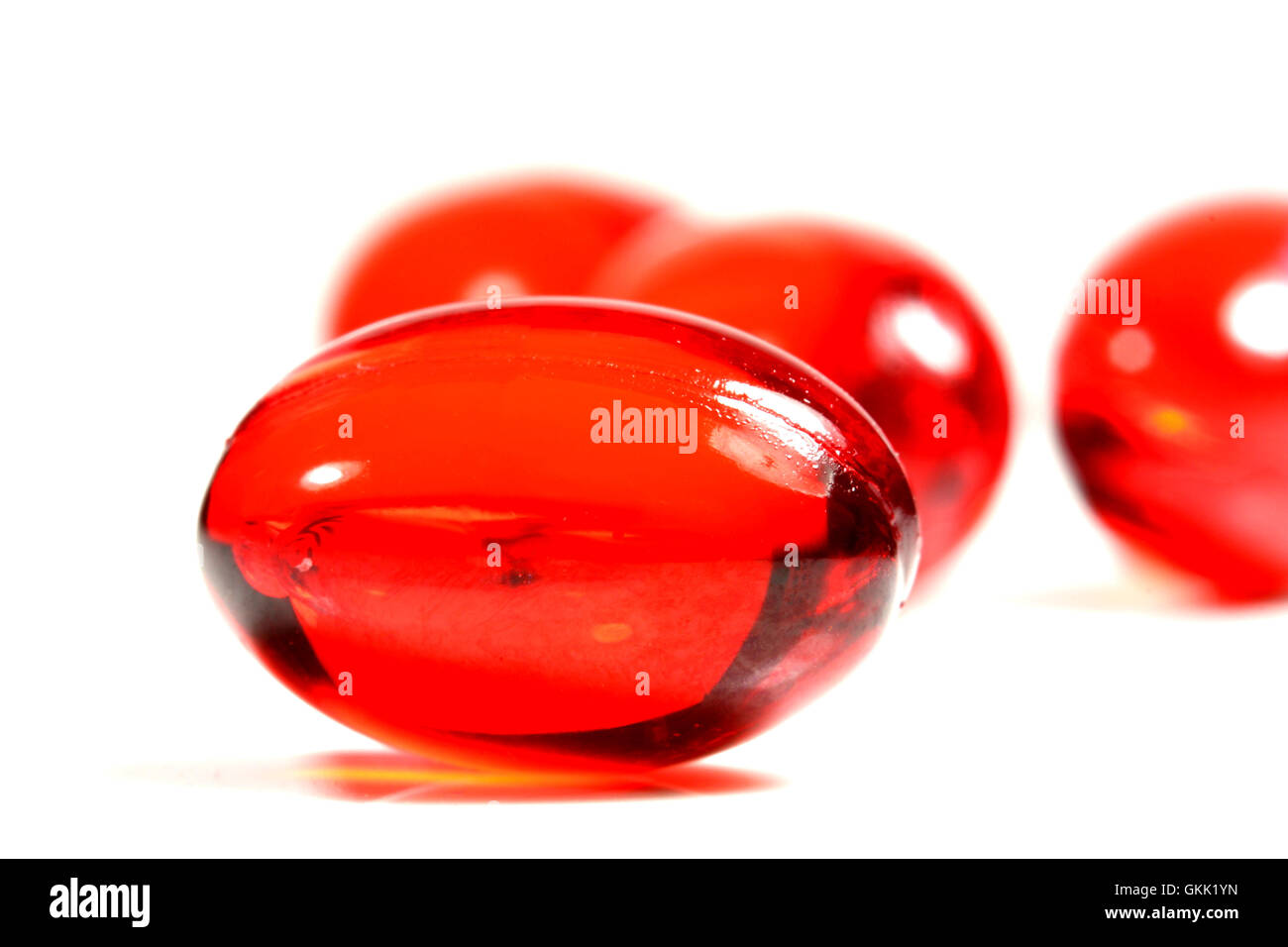 Red liquid capsule pills Stock Photo - Alamy