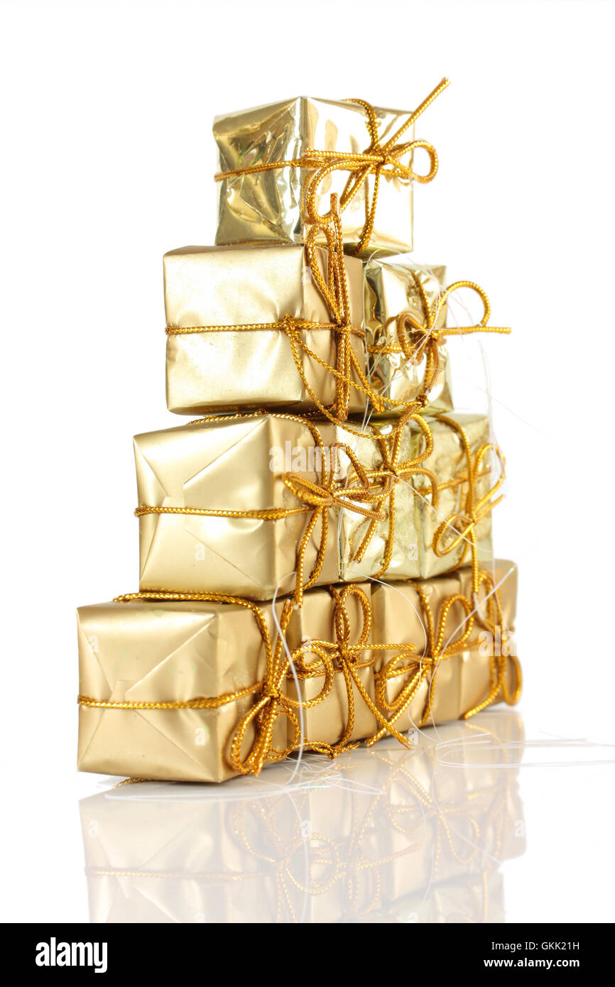 Gold gift wrapped parcels in a pyramid Stock Photo - Alamy