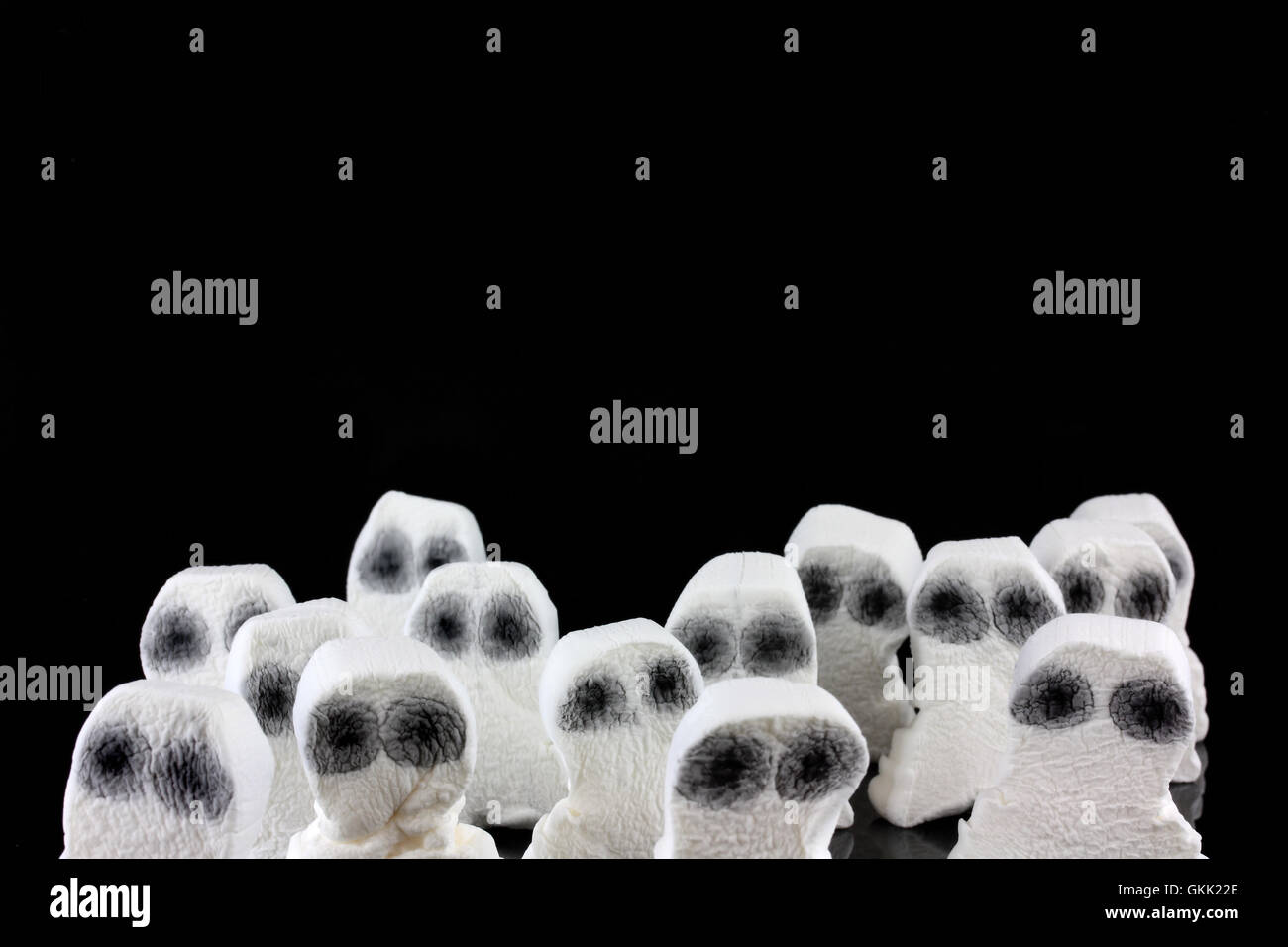 Evil white ghosts in a crowd with black space Stock Photo - Alamy