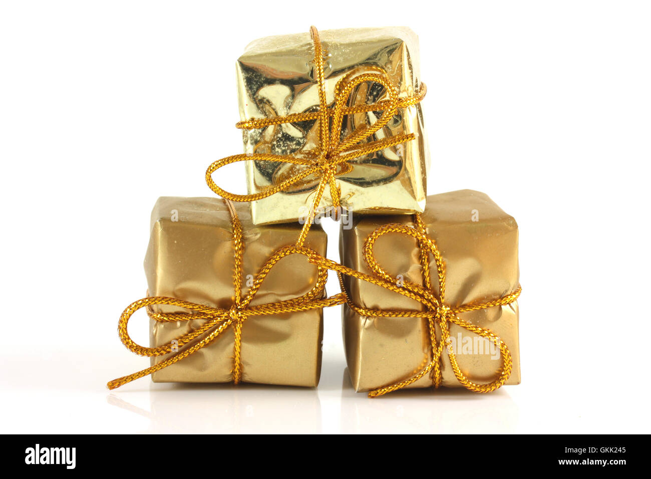 Three gold box parcels on a white background Stock Photo - Alamy