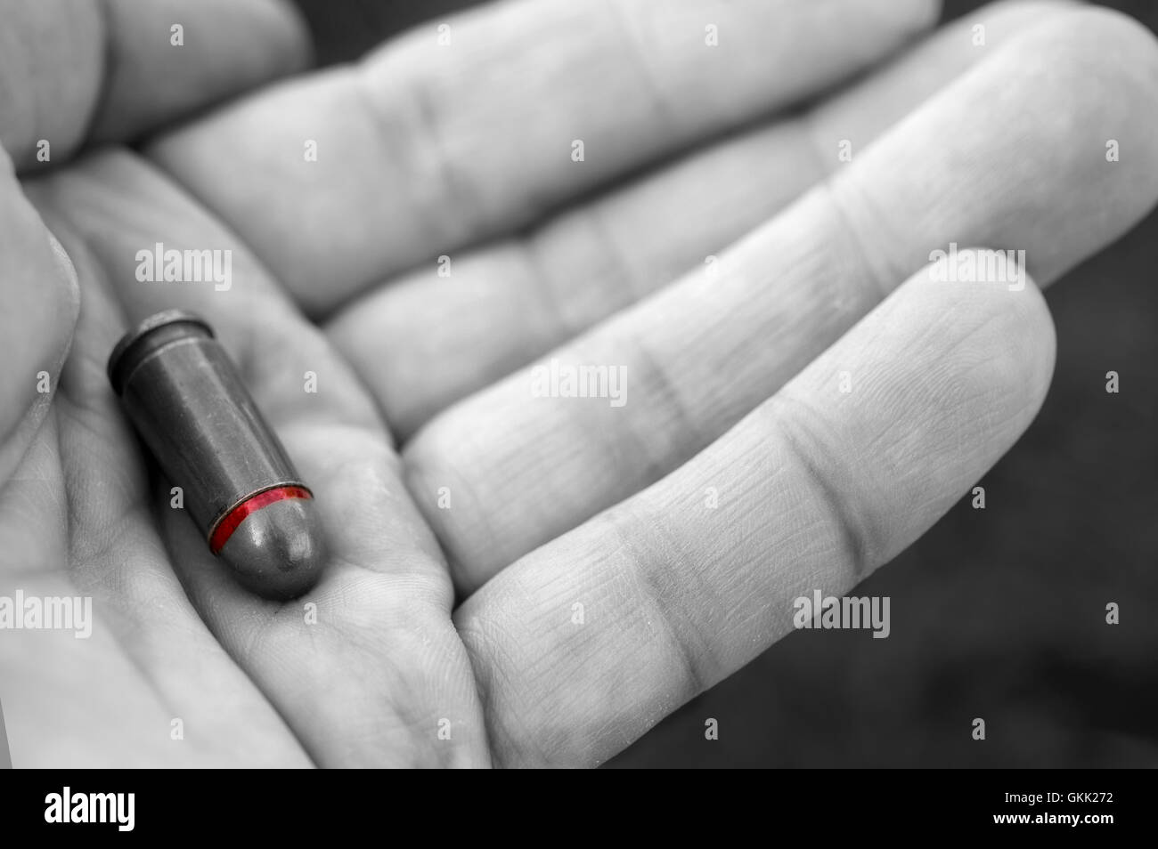Bullet In A Hand Stock Photo - Alamy