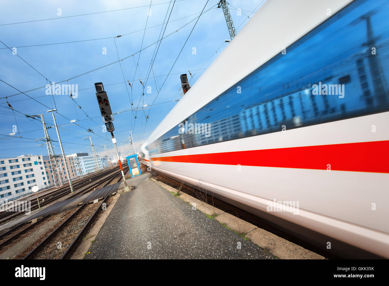 Modern high speed passenger train on railroad track in motion at sunset ...
