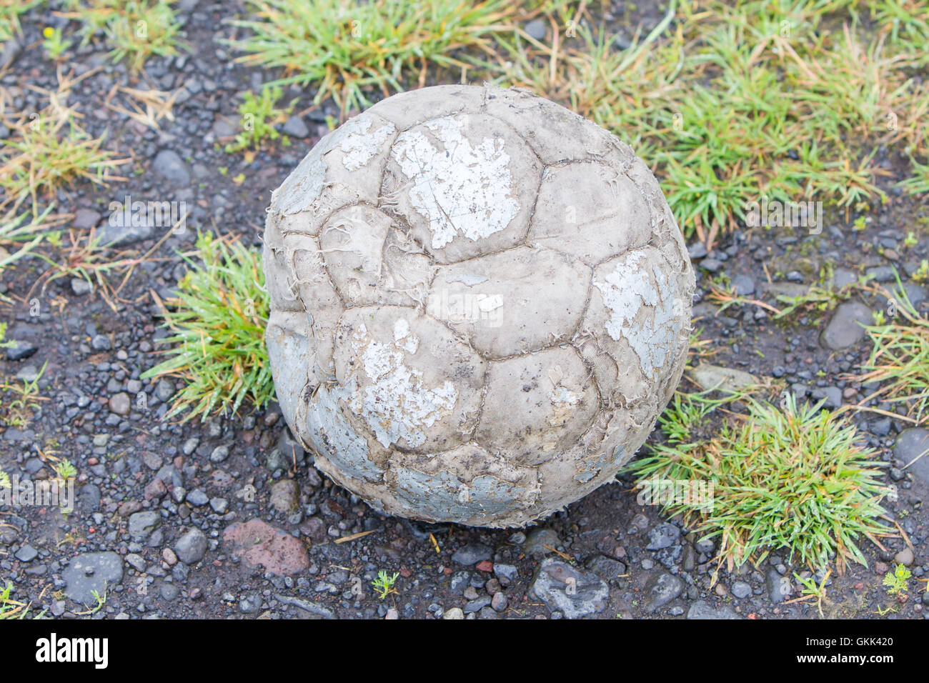 Old football isolated, used by a dog Stock Photo - Alamy