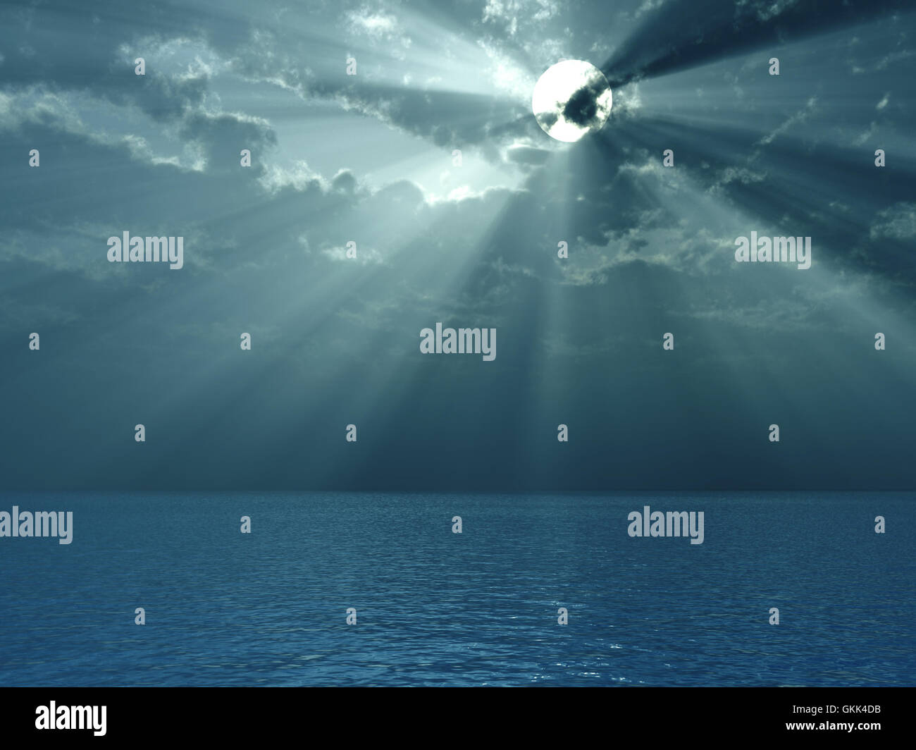 Solar beams breaking through clouds above a quiet surface of ocean ...