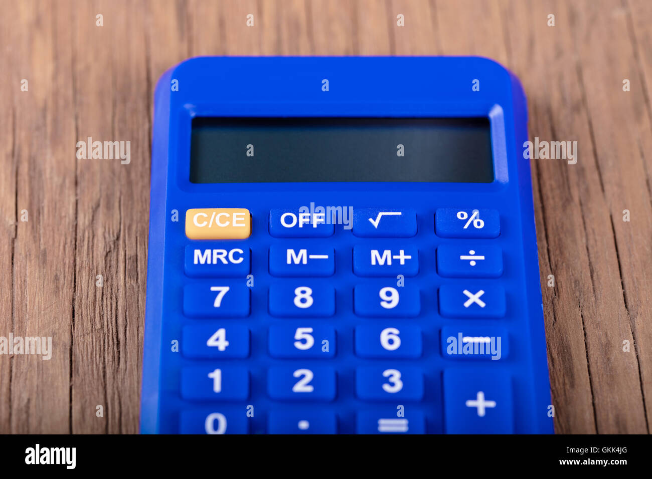 blue calculator closeup on the wooden background Stock Photo - Alamy