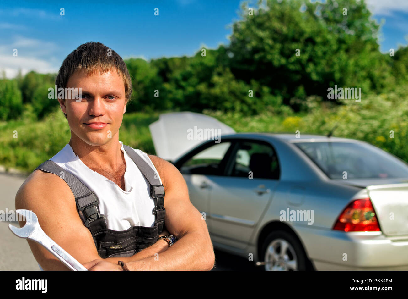 Handsome mechanic on a road near the broken car Stock Photo - Alamy
