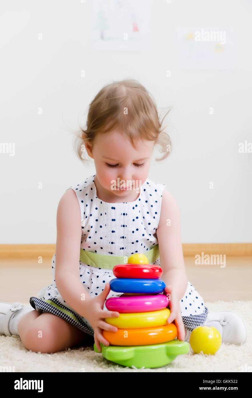 Little girl playing in a pyramid toy Stock Photo - Alamy