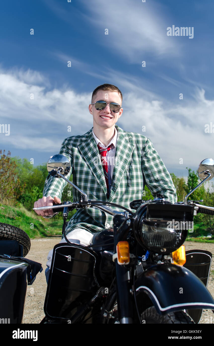 Classy guy on a motorcycle with a sidecar Stock Photo - Alamy