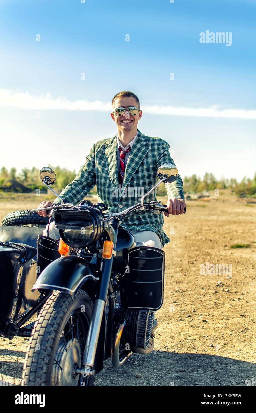 Classy guy on a motorcycle with a sidecar Stock Photo - Alamy