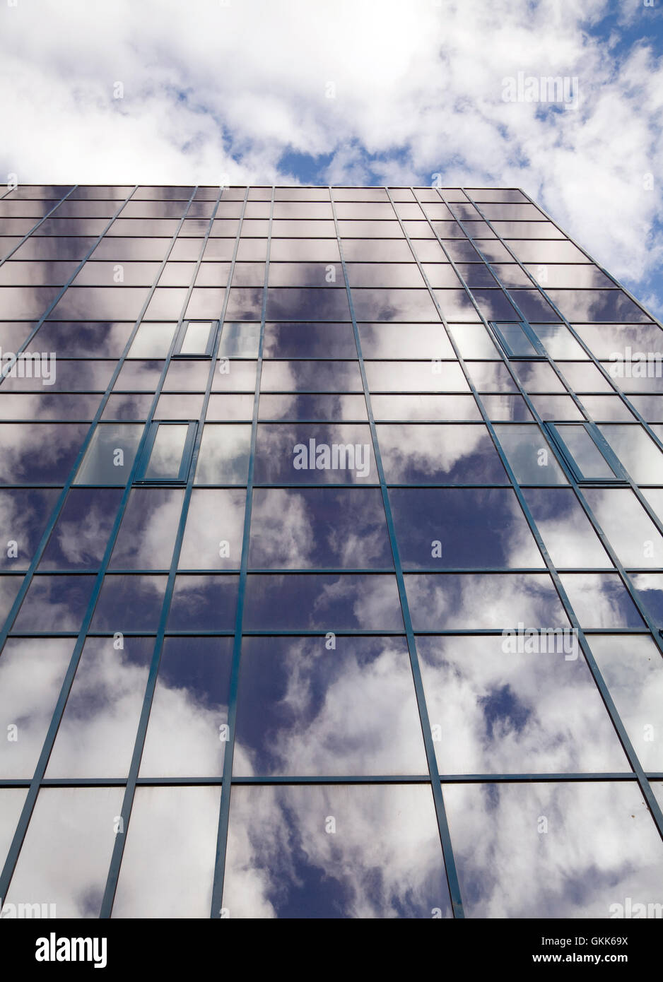 windows of skyscraper with reflections on a background cloudy sky Stock ...
