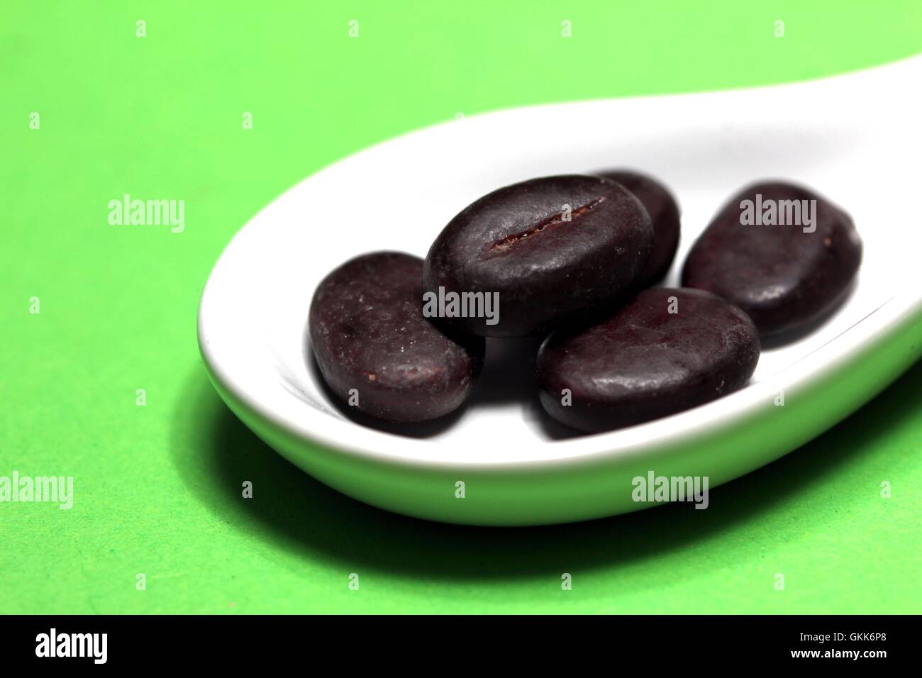 mocha beans on a porcelain spoon Stock Photo - Alamy