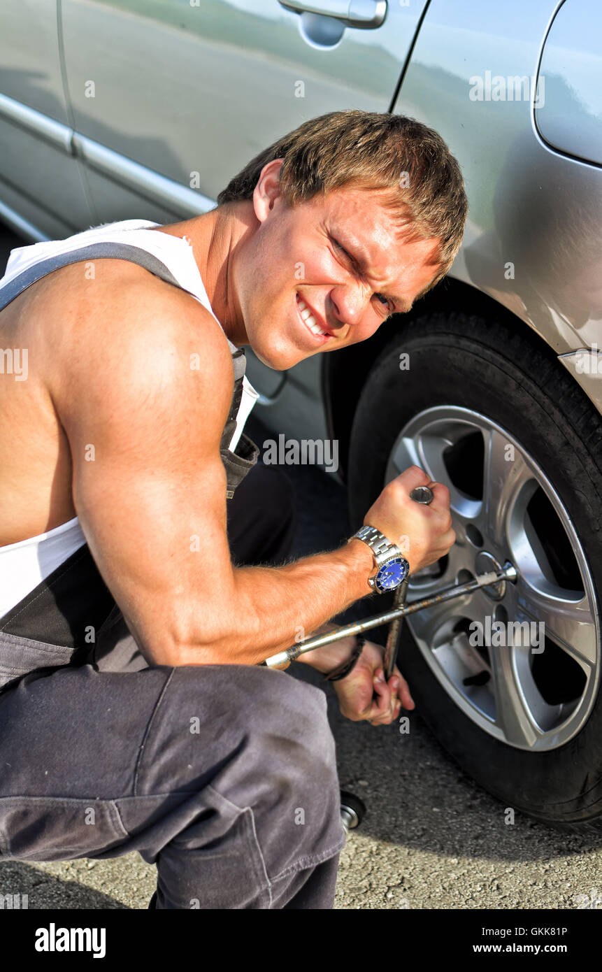 Mechanic fixing a tire on a road Stock Photo - Alamy