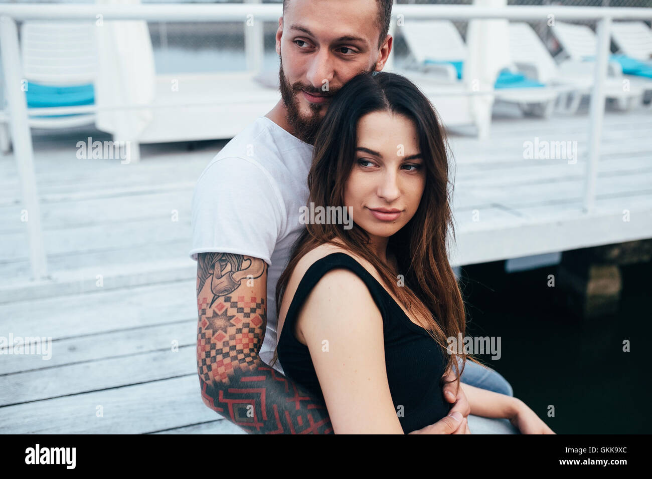 Couple hugging on pier Stock Photo - Alamy