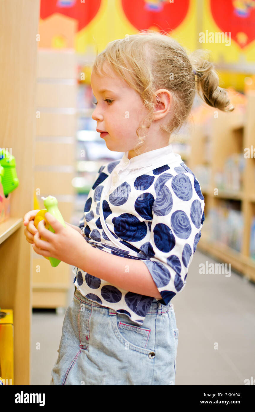 Little girl is shopping at the children's store Stock Photo - Alamy