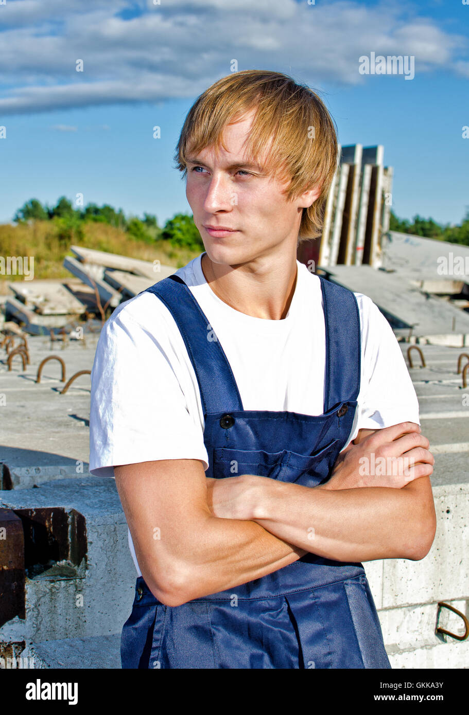 Handsome builder in coveralls on construction site Stock Photo - Alamy