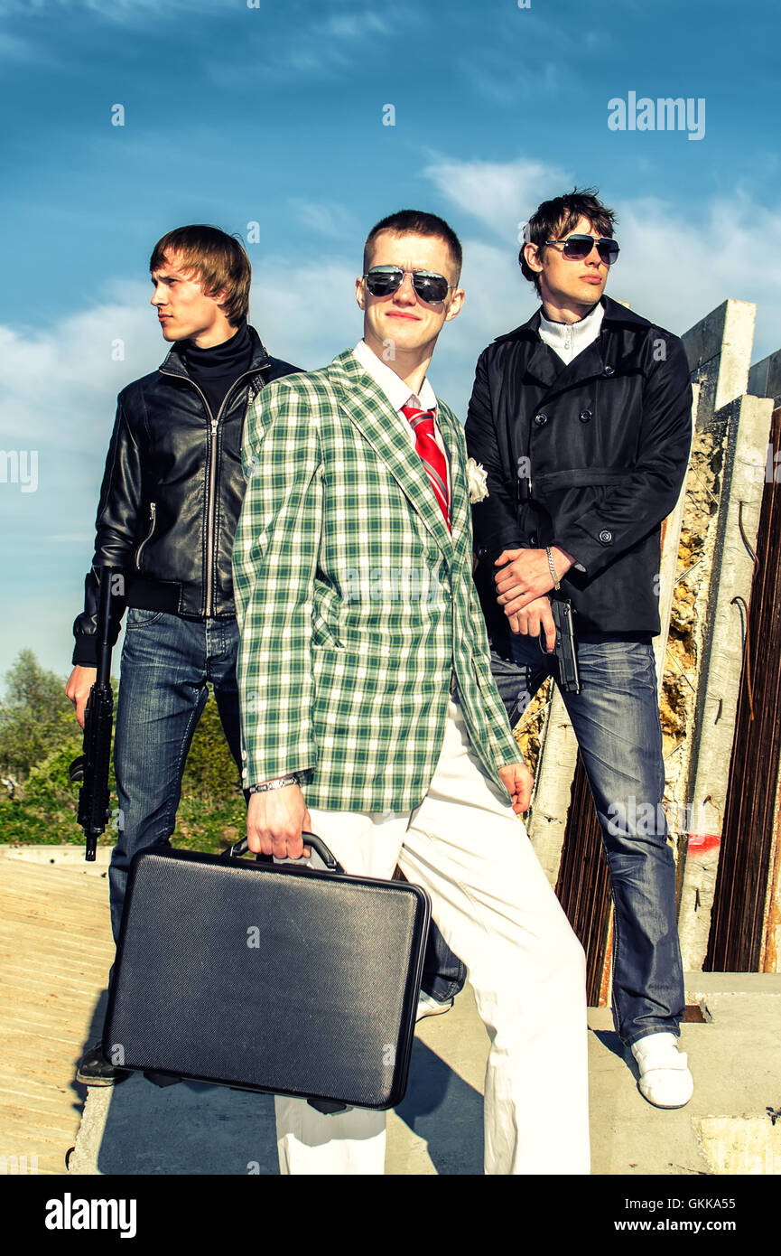 Mafia: Three thugs with a suitcase and weapons Stock Photo - Alamy