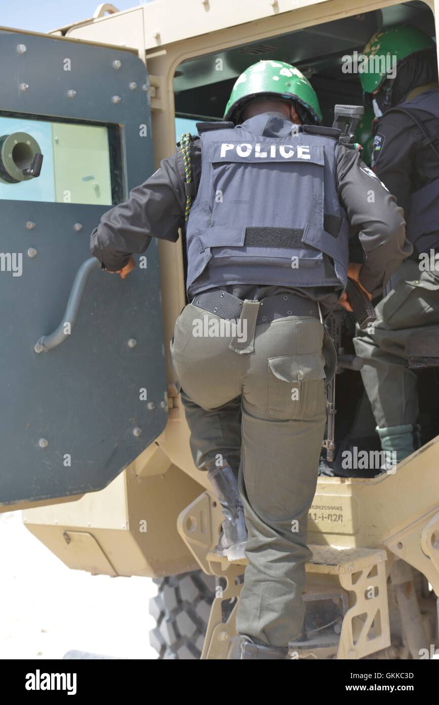A Nigerian member of the AMISOM Police boards a casper vehicle for ...