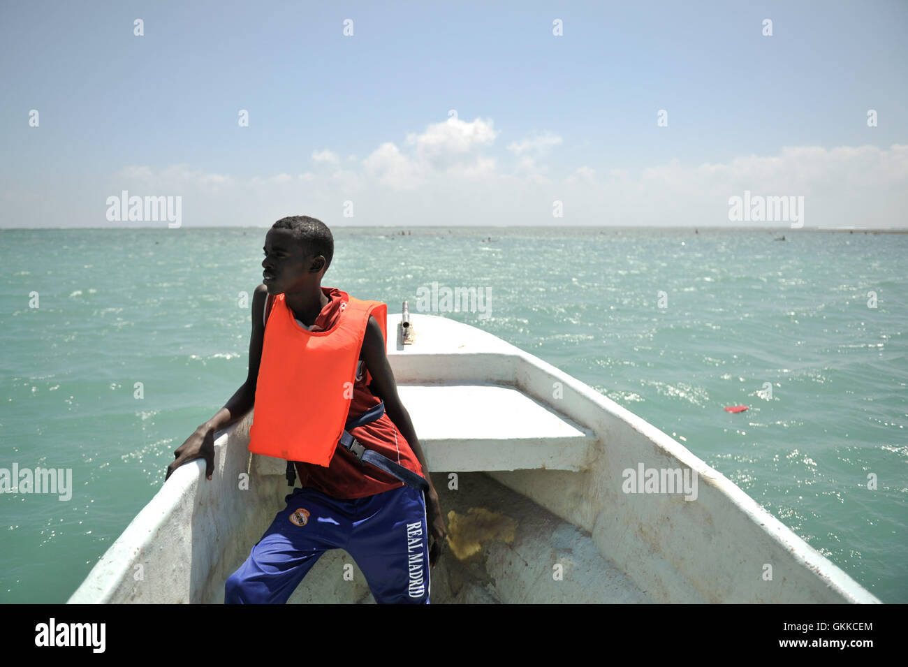 A young lifeguard keeps an eye out for swimmers in distress while ...